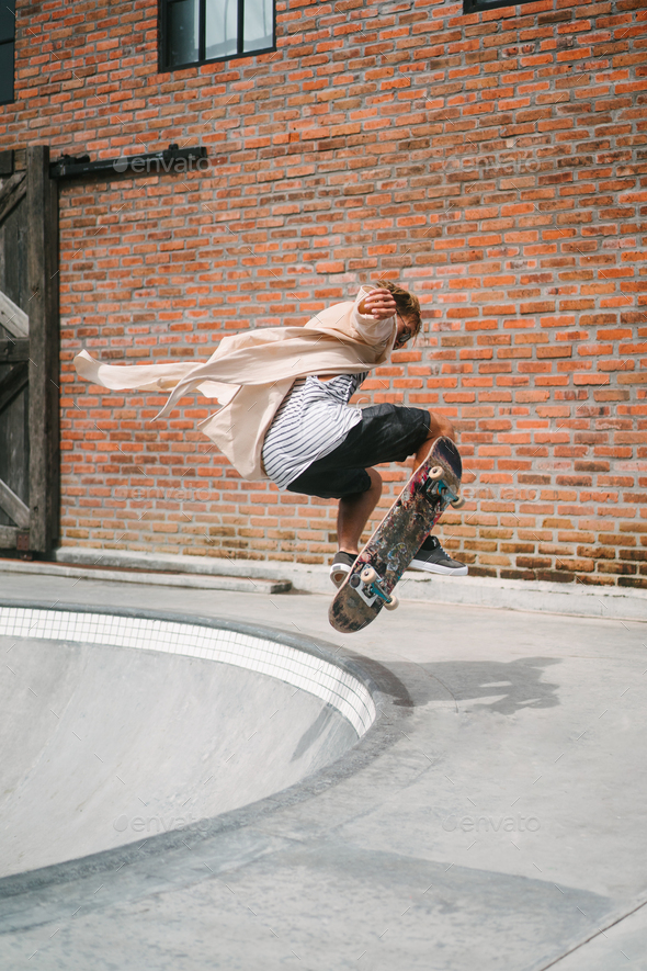 handsome skater jumping from pool in skatepark Stock Photo by ...