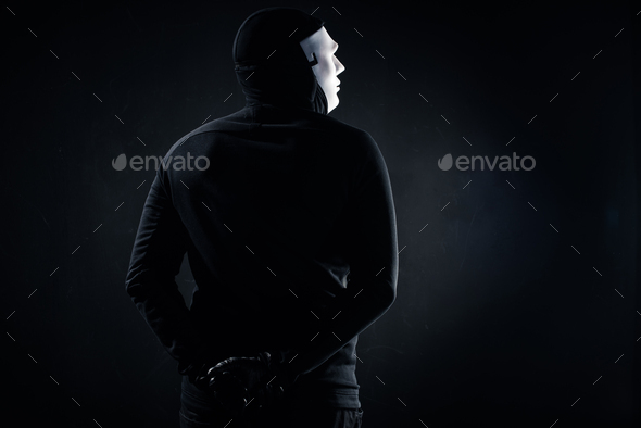 Rear view of male criminal in mask and balaclava Stock Photo by ...