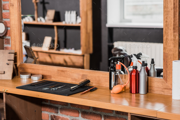barber tools and spray bottles on counter at barbershop Stock Photo by ...