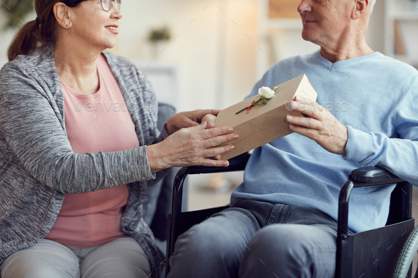 Wife giving gift to disabled husband Stock Photo by Media_photos ...