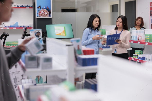 Medical consultant helping asian client with healthcare products Stock ...