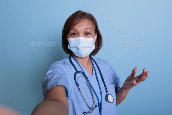 Medical assistant wearing protective face mask to prevent infection ...