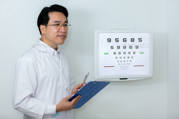 Man ophthalmologist wear uniform holding clipboard standing near eye ...