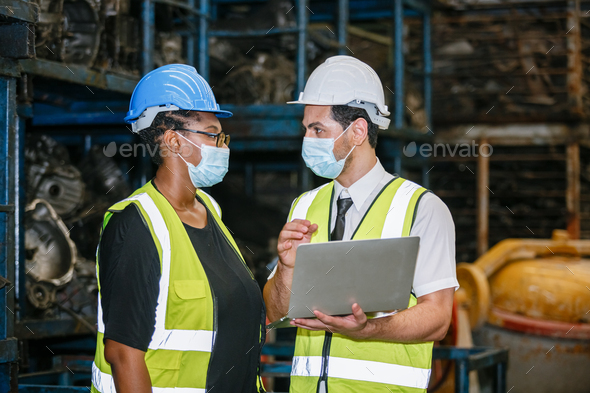 Team engineering two nationality wear face mask uniform working with ...