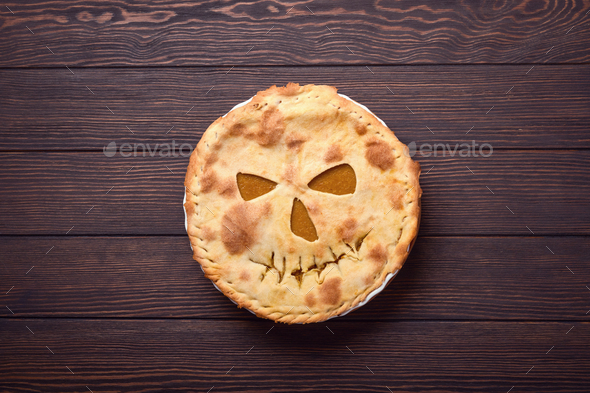 Halloween food. Homemade pumpkin pie or tart with a scary face for ...