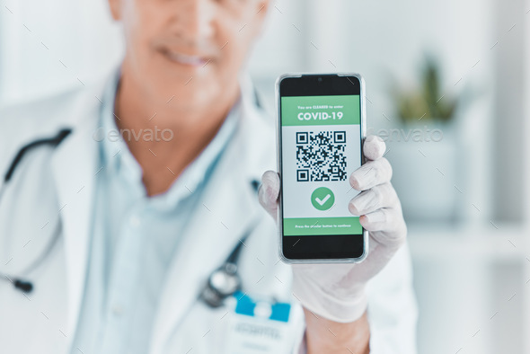 Shot of a male doctor holding a smartphone depicting a QR code to be ...