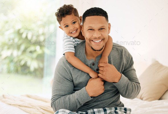 Extra hugs to get dad through the day. Portrait of a young father and ...
