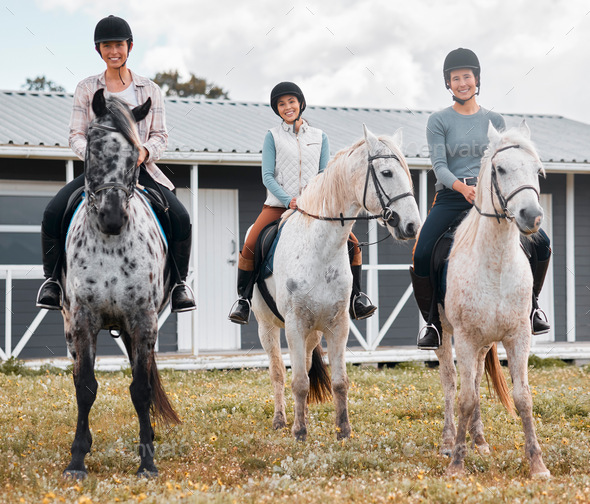 On horseback. Full length portrait of three attractive young women ...
