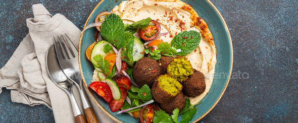 Middle Eastern Arab meal with fried falafel, hummus, vegetables salad ...