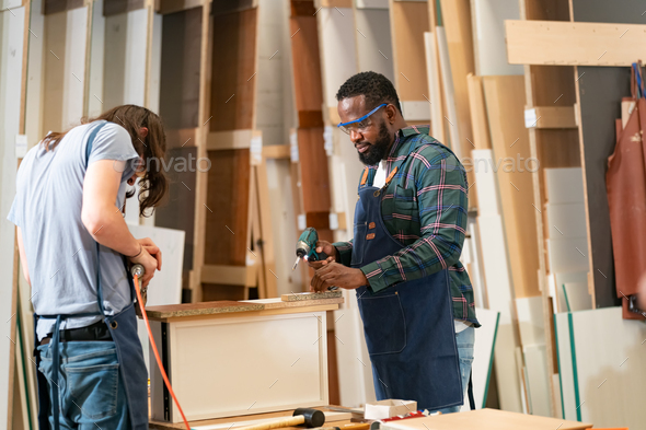 Carpenter working on the woodworking desk and furniture handmade with ...