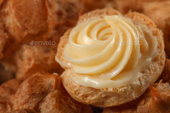 Custard-filled profiteroles ready to serve. Stock Photo by Shandor_gor