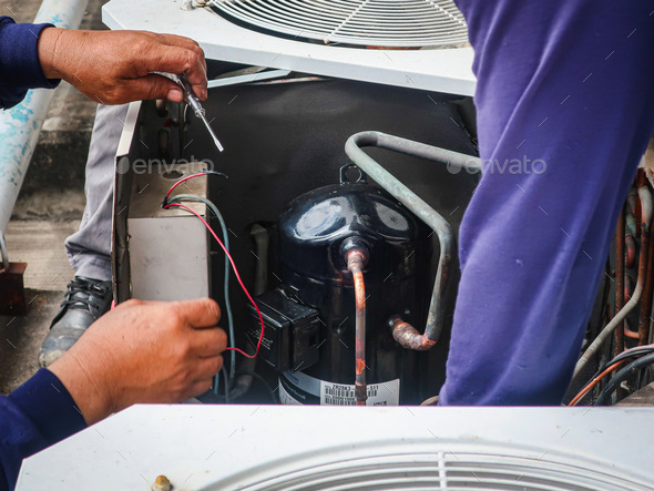 Maintenance man repair air conditional and air compressor of the ...