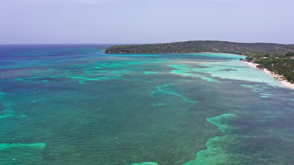 Aerial forward over Caribbean waters of Playa Ensenada beach in ...