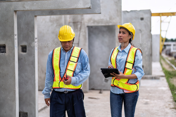 At building construction site senior engineer and supervisor check ...