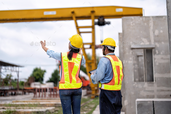 At construction site senior engineer and supervisor check overhead ...