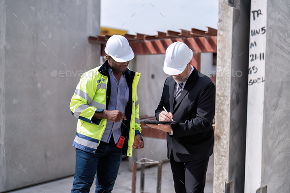 At construction site manager meet senior civil engineer check project ...