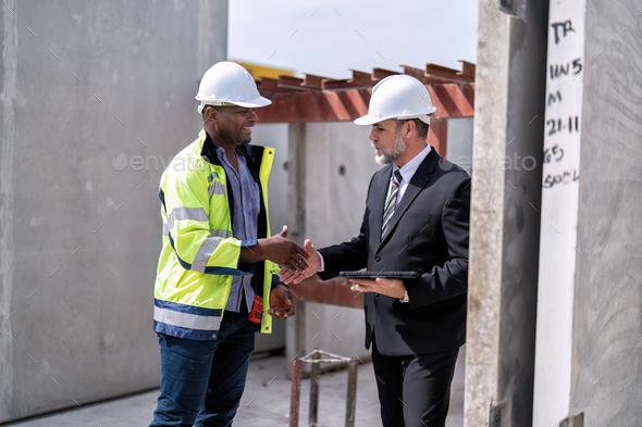 At construction site manager meet senior civil engineer check project ...