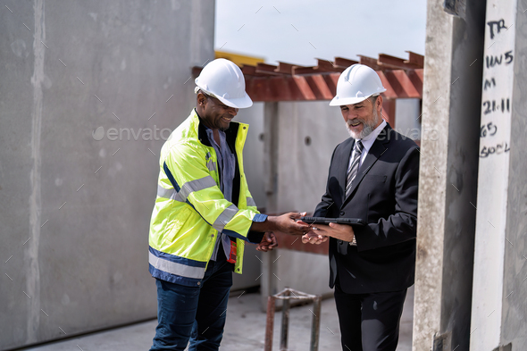 At construction site manager meet senior civil engineer check project ...