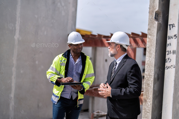 At construction site manager meet senior civil engineer check project ...