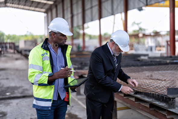 At construction site manager meet engineer check precast concrete slabs ...