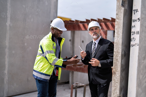 At construction site manager meet senior civil engineer check project ...