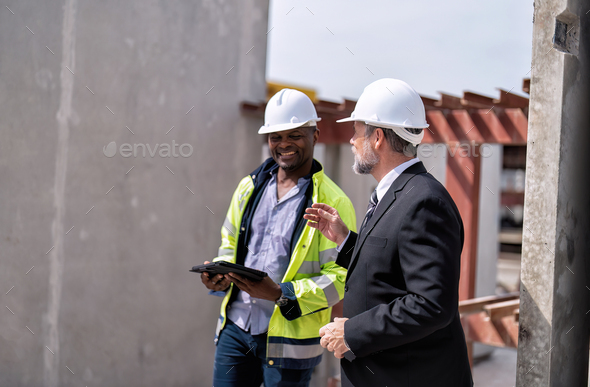 At construction site manager meet senior civil engineer check project ...