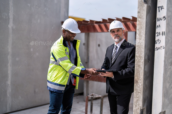 At construction site manager meet senior civil engineer check project ...