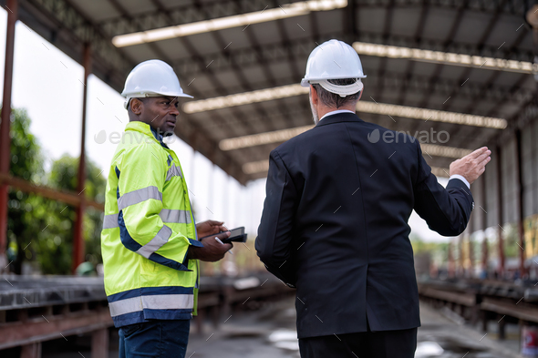 At construction site manager meet engineer check precast concrete slabs ...