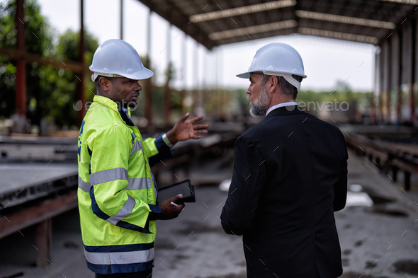 At construction site manager meet engineer check precast concrete slabs ...