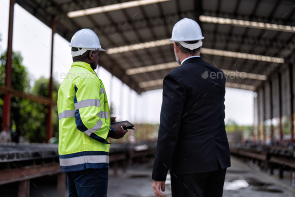 At construction site manager meet engineer check precast concrete slabs ...