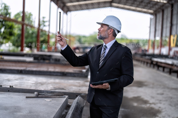 At building construction site manager check precast concrete slabs hall ...