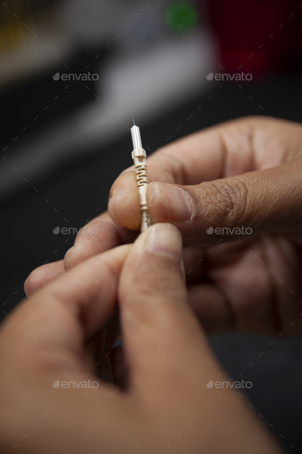 Technician cleaving an optical fiber, a crucial process for a good ...