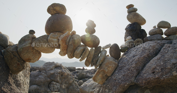 Arch of pebbles in balancing on the sea coast Stock Photo by leungchopan