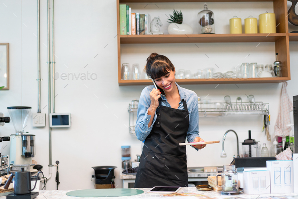 Female barista talking and receiving customer order at the coffee shop ...