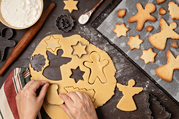 Christmas cookies baking process. Cutting buiscuits with cookies cutter ...