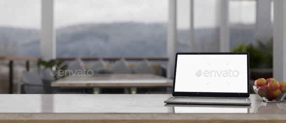 Notebook laptop mockup and copy space on tabletop over blurred coffee ...