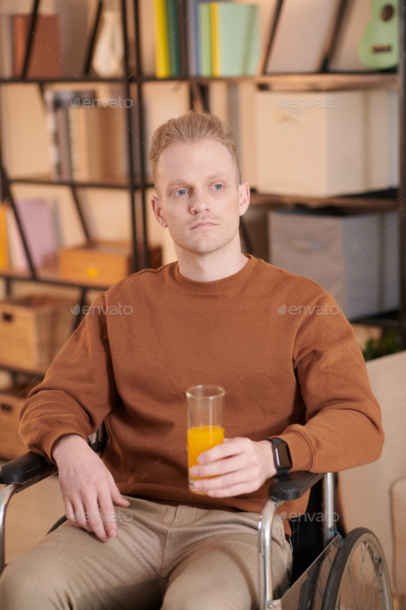 Pensive Man Sitting in Wheelchair Stock Photo by DragonImages | PhotoDune