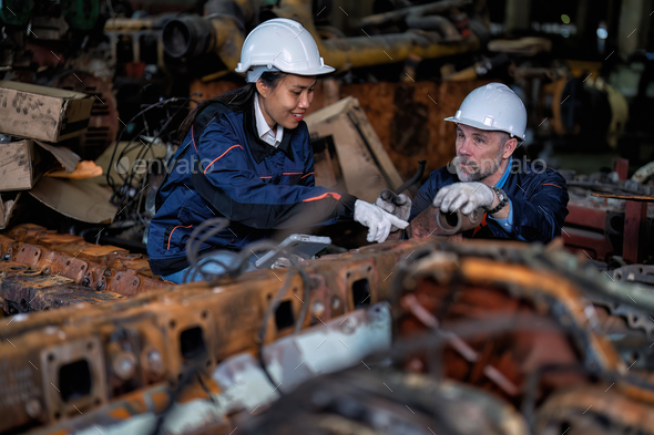 Maintenance manager and engineer checking part large engine ...