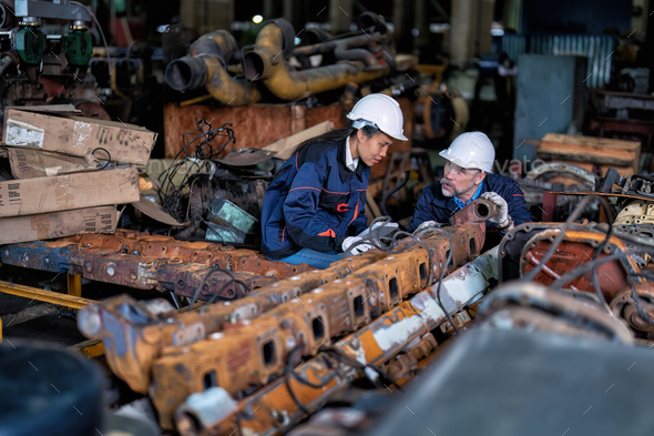 Maintenance manager and engineer checking part large engine ...