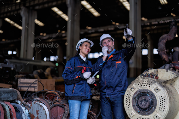 Maintenance manager and engineer checking part large engine ...