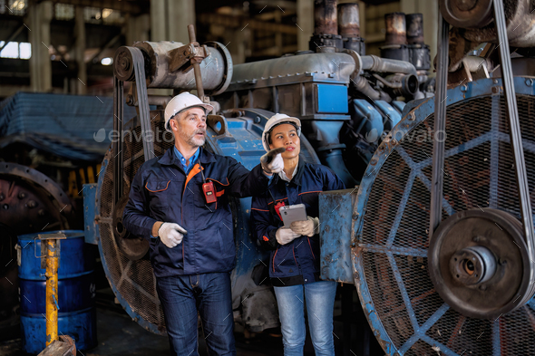 Maintenance manager and engineer checking part large engine ...