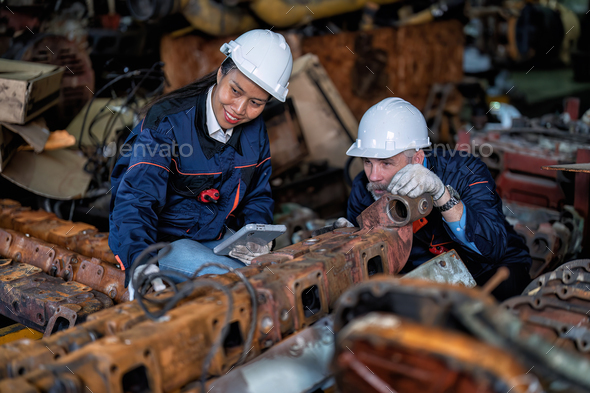 Maintenance manager and engineer checking part large engine ...