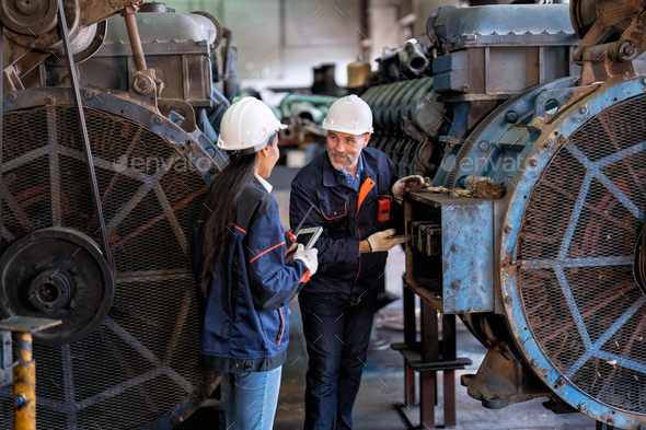Maintenance manager and engineer checking part large engine ...