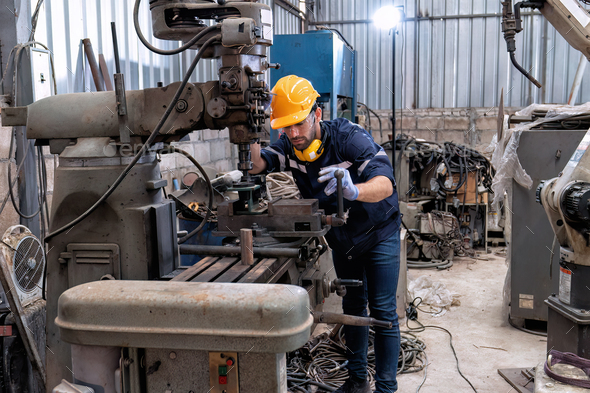 In robotic repair shop engineer use drilling machine fabricate part and ...