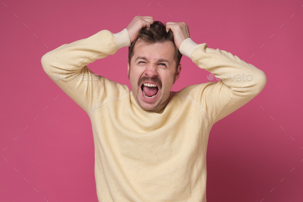 Shocked handsome guy holding hand on his head being in panic. Stock ...