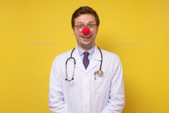 Funny caucasian doctor with clown red nose smiling at camera Stock ...