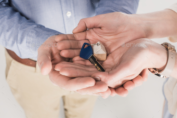 partial view of couple holding key from new home together Stock Photo ...