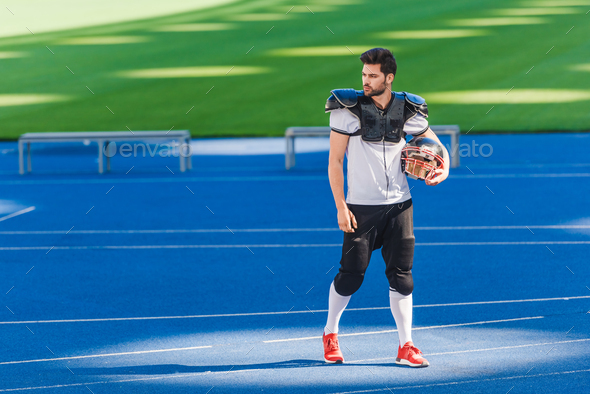 attractive young american football player standing alone at sports ...