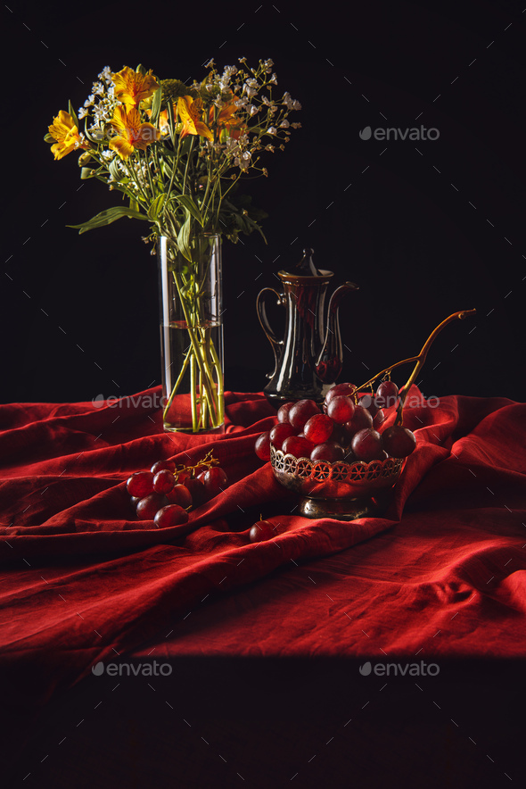 still life of grapes in metal bowl with flowers in vase and turkish ...