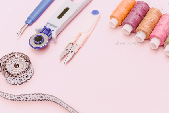 Pink background with sewing accessories and fabric, tailoring supplies ...